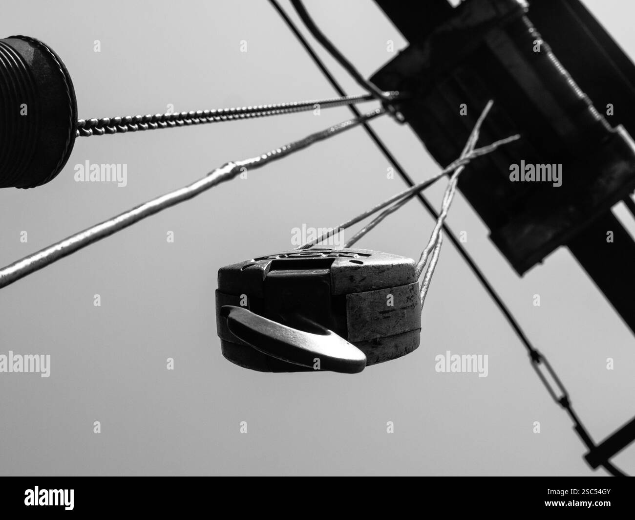 Black and white close-up of an industrial pulley system with steel ...