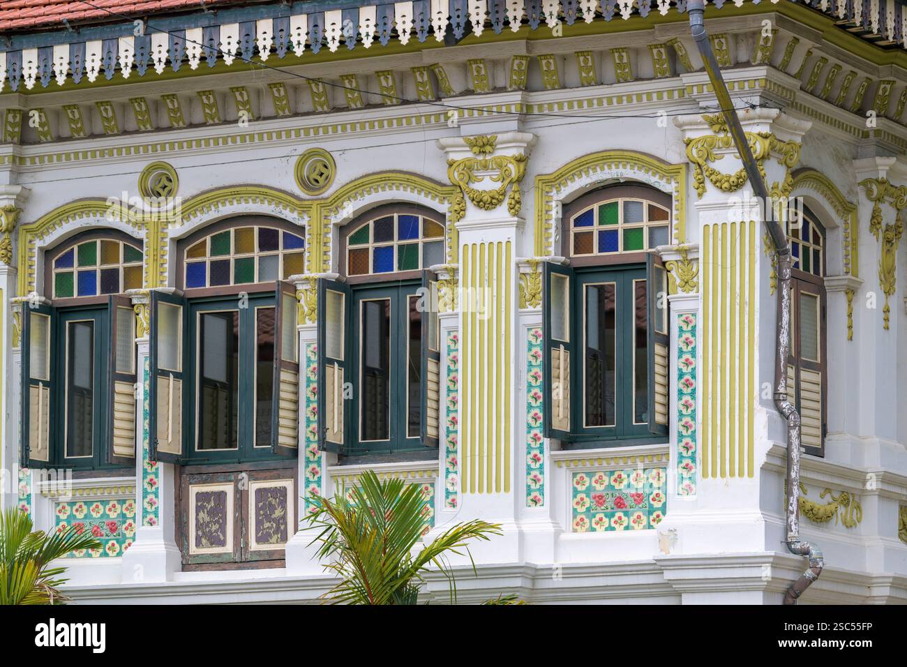 Elaborate and colourful windows adorn a traditional Peranakan row house ...