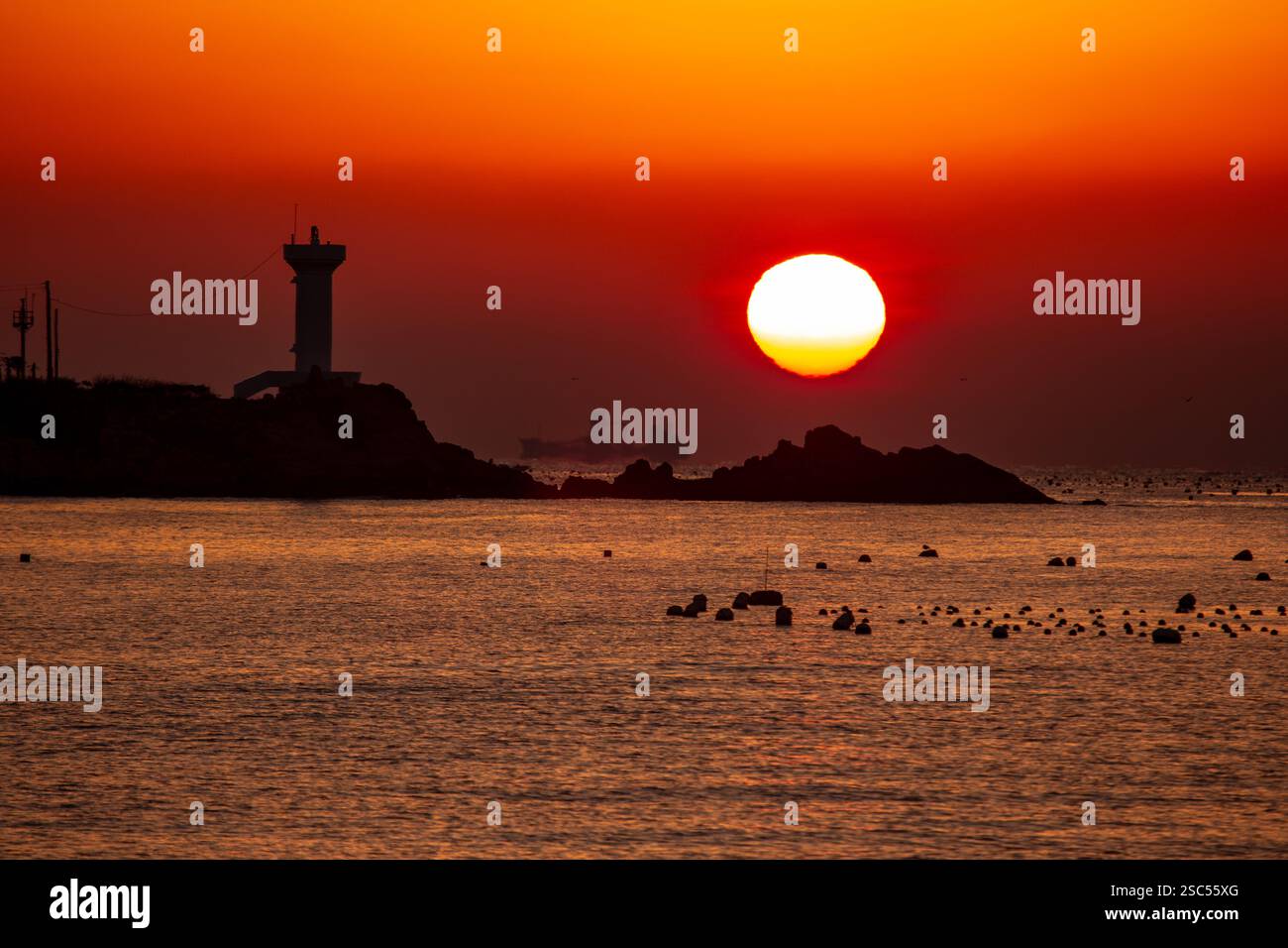 the sun rising over the lighthouse, the sunrise of the sea Stock Photo ...