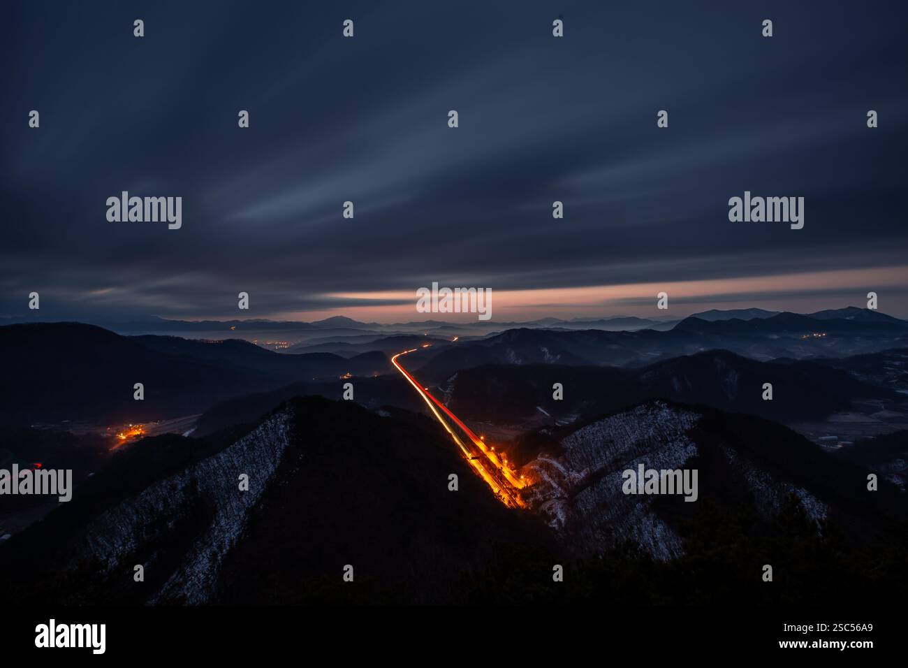 the highway between the mountains and the sunrise scenery Stock Photo ...