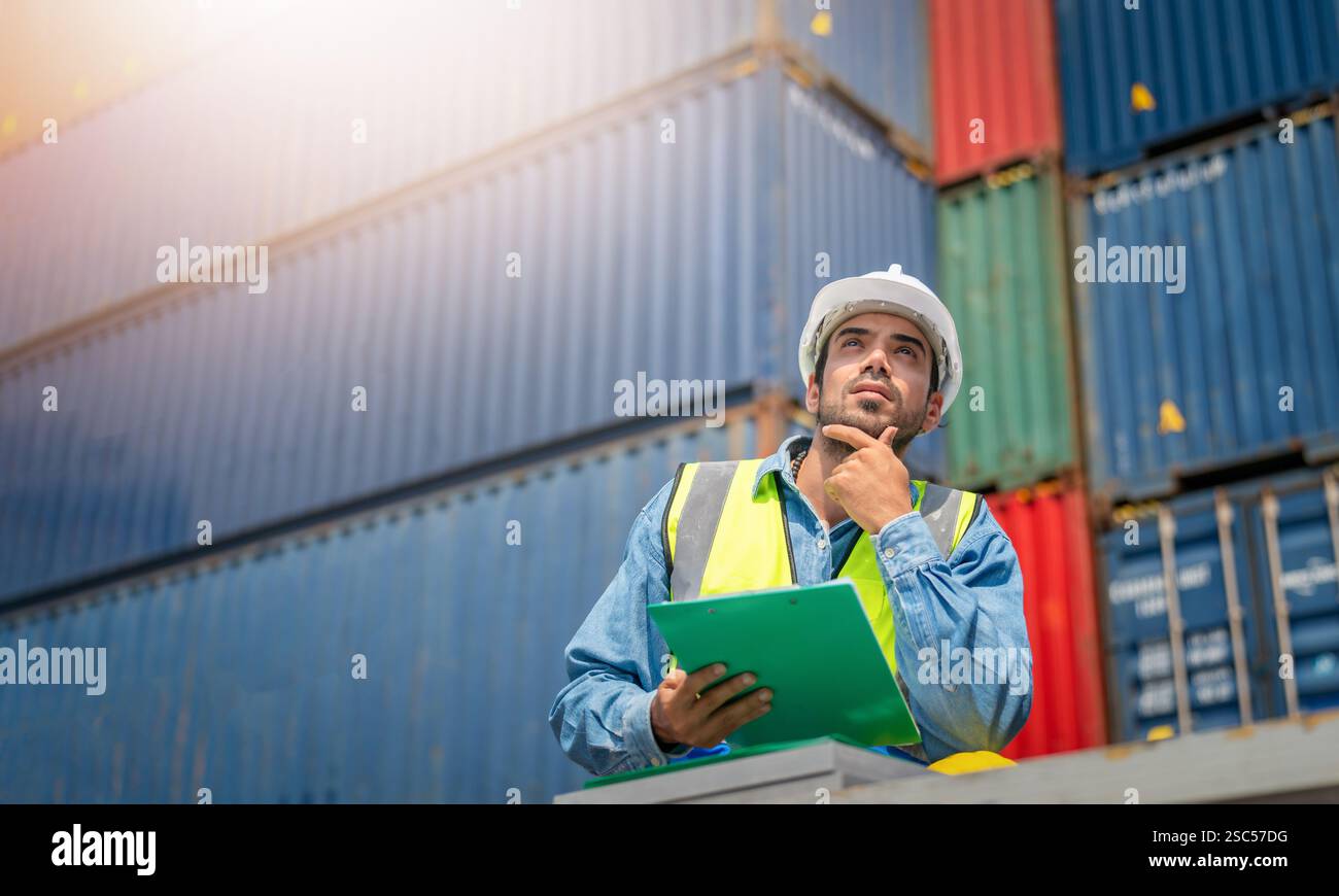 Engineer wears PPE checking container storage with cargo container ...