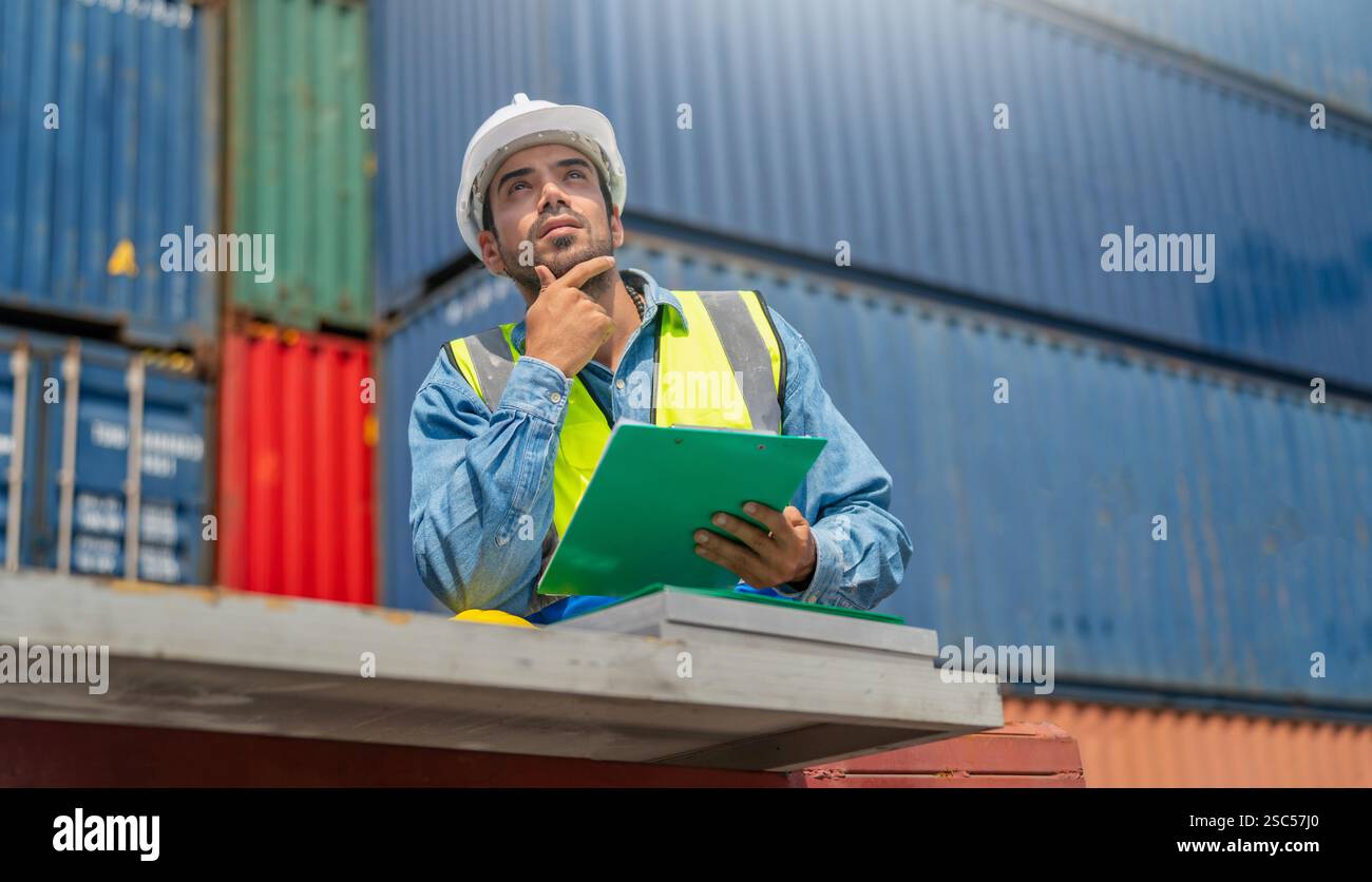 Engineer wears PPE checking container storage with cargo container ...