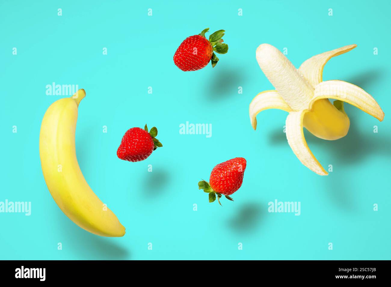 banana and strawberry fruits turquoise background Stock Photo - Alamy