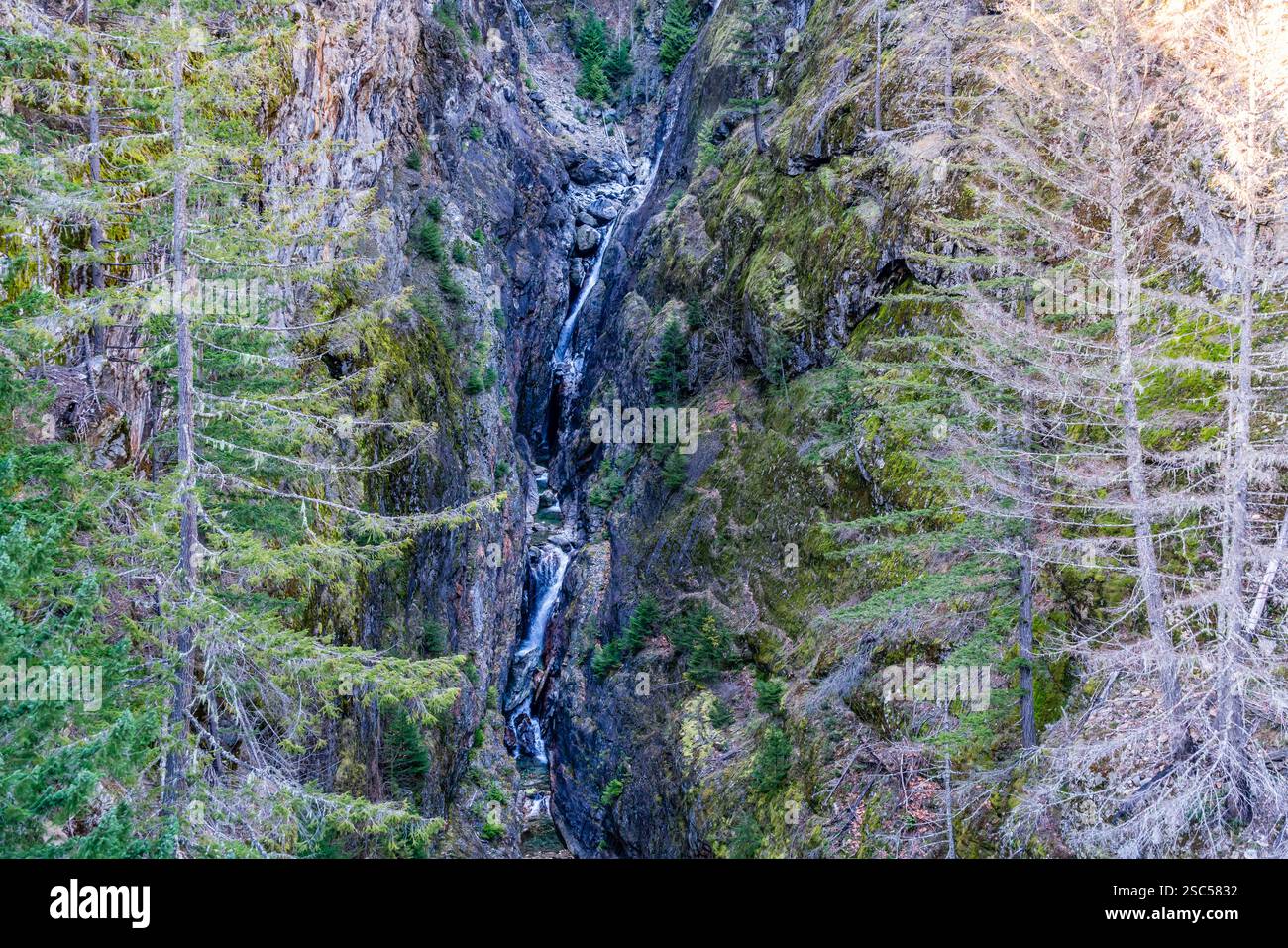 A view of a stream flowing down steep cliffs along Highway 20 in ...