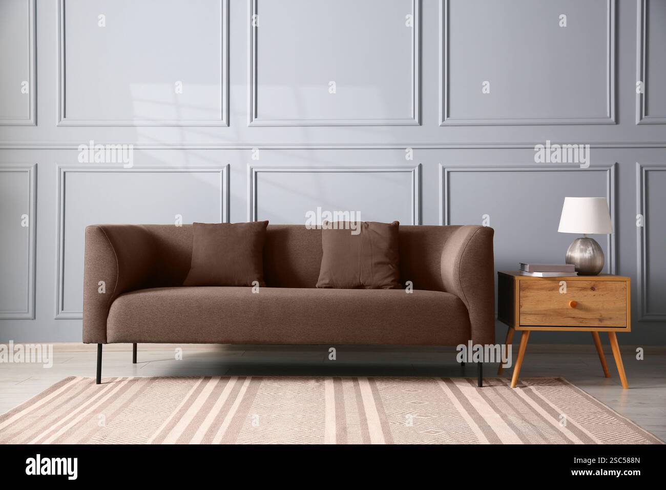 Sofa in mocha mousse shade indoors. Cozy interior with trendy color of 2025 year Stock Photo - Alamy