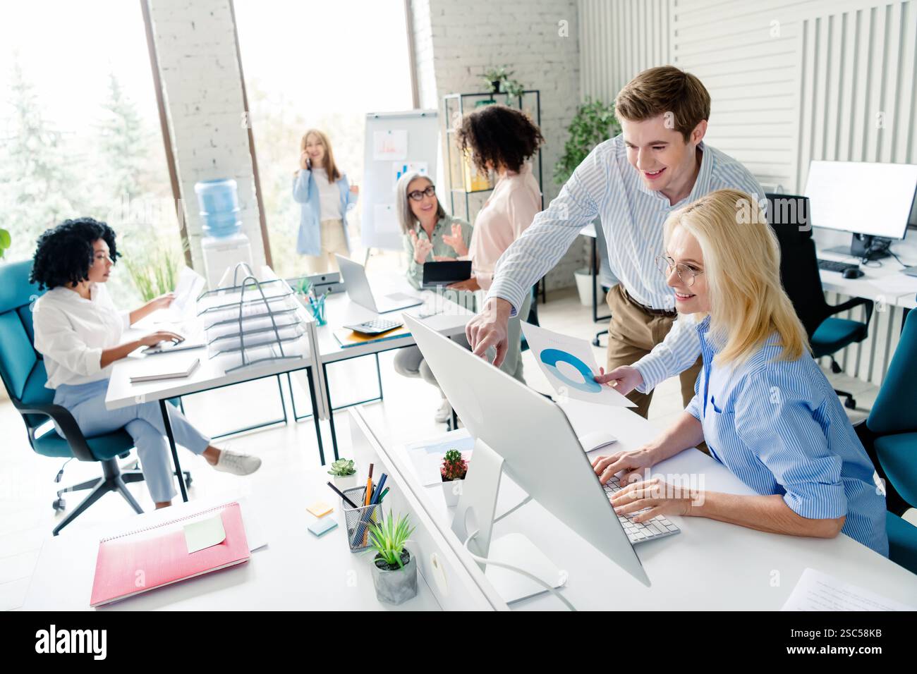 Professional team working together in a modern, collaborative office ...