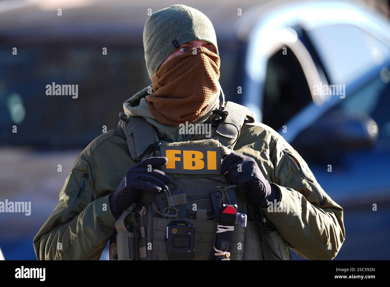 An agent from the Federal Bureau of Investigation stands watch outside ...