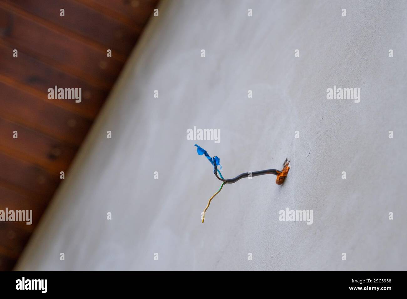 Wire sticking out of the wall of the house from the outside, view from ...