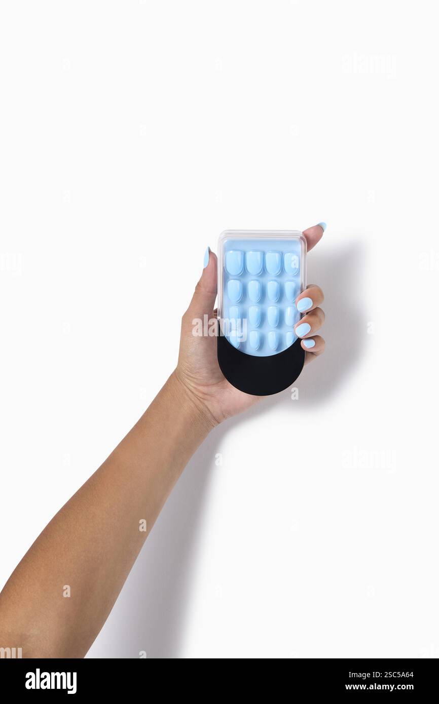 woman hand with false nails after nail salon on a white background ...