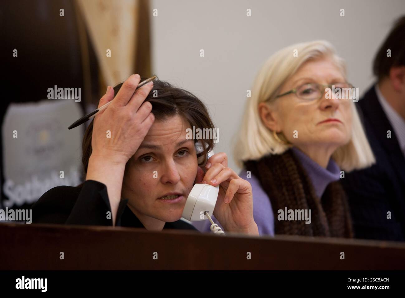 Staff from Sotherby's International Wine Department handle telephone ...