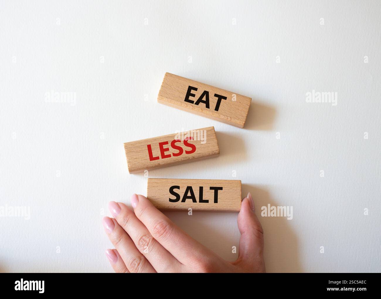 Eat less salt symbol. Concept word Eat less salt on wooden blocks ...