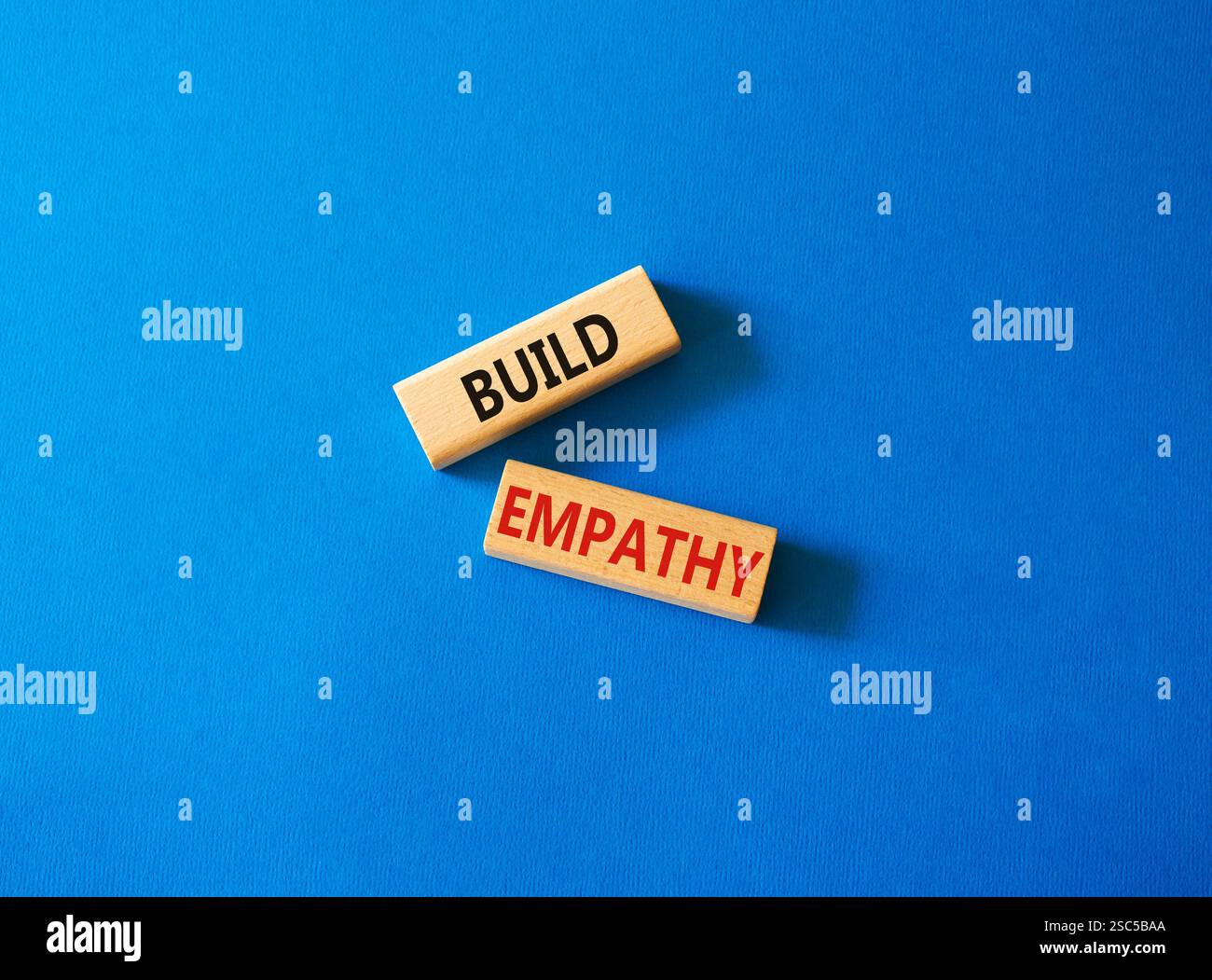 Build empathy symbol. Wooden blocks with words Build empathy. Beautiful ...