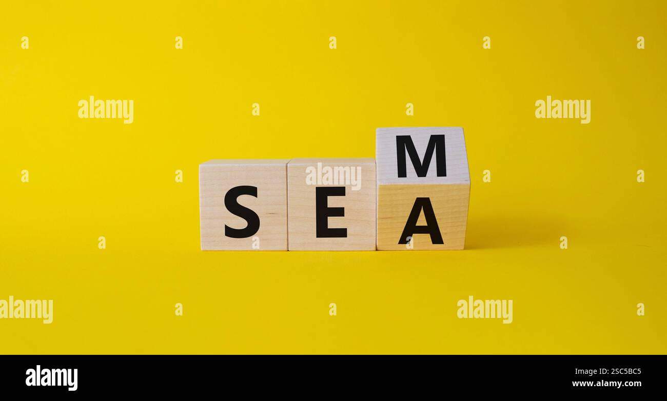 SEM vs SEA symbol. Turned wooden cubes with words SEA and SEM ...