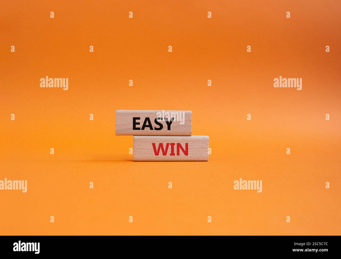 Easy win symbol. Wooden blocks with words Easy win. Beautiful orange ...