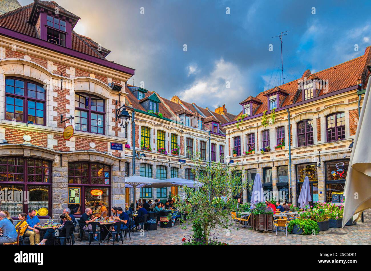 Lille, France, July 3, 2023: people sit in street restaurants in ...