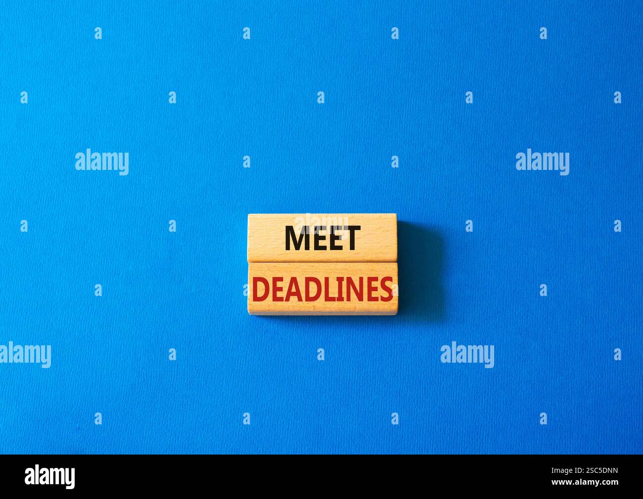Meet Deadlines symbol. Concept word Meet Deadlines on wooden blocks ...