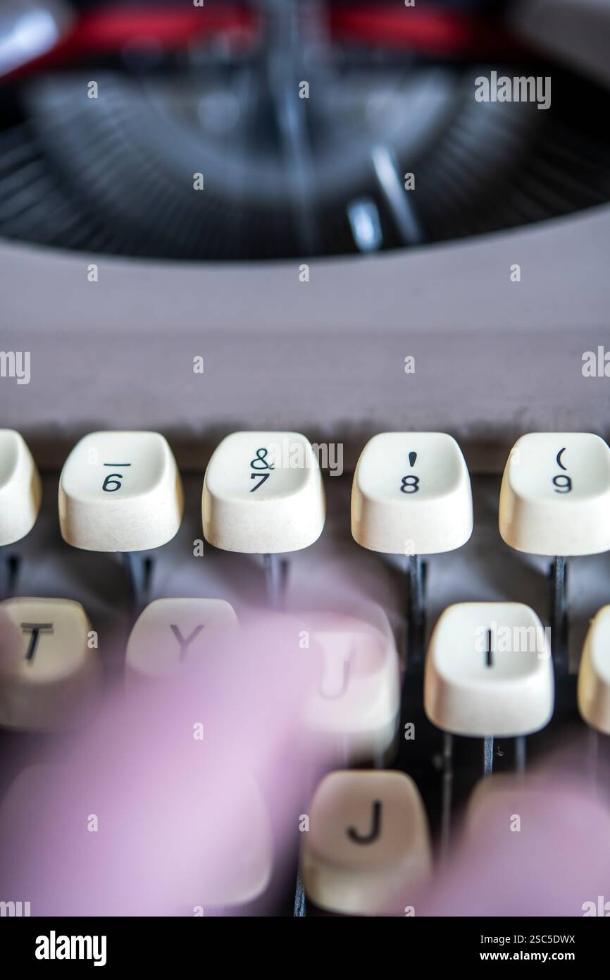 Detail of someone typing on an old manual typewriter Stock Photo - Alamy