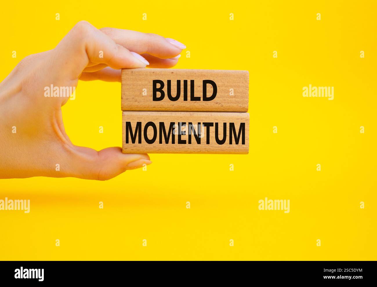 Build momentum symbol. Wooden blocks with words Build momentum ...
