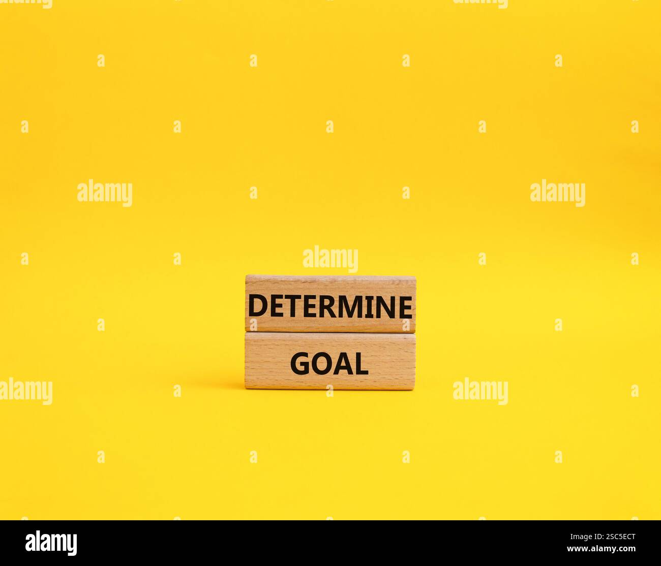 Determine goal symbol. Wooden blocks with words Determine goal ...