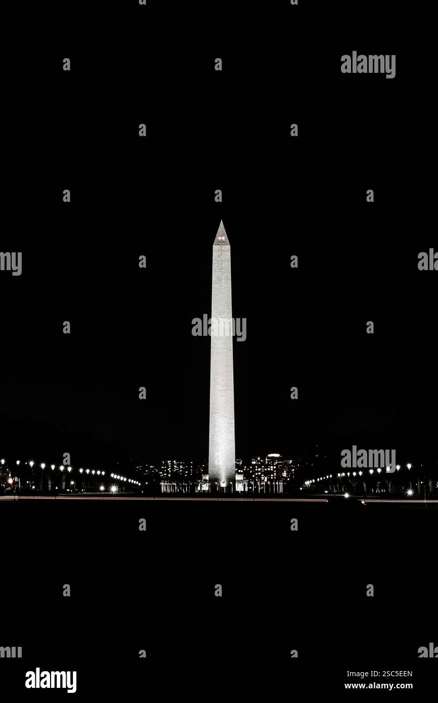 The Washington Monument stands tall and illuminated against the inky ...