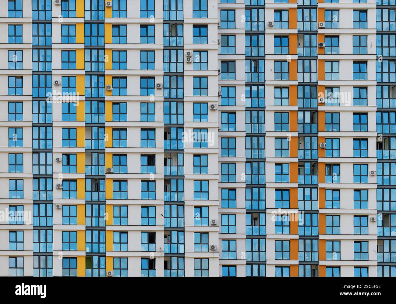 Modern residential building facade with multiple windows and colorful ...