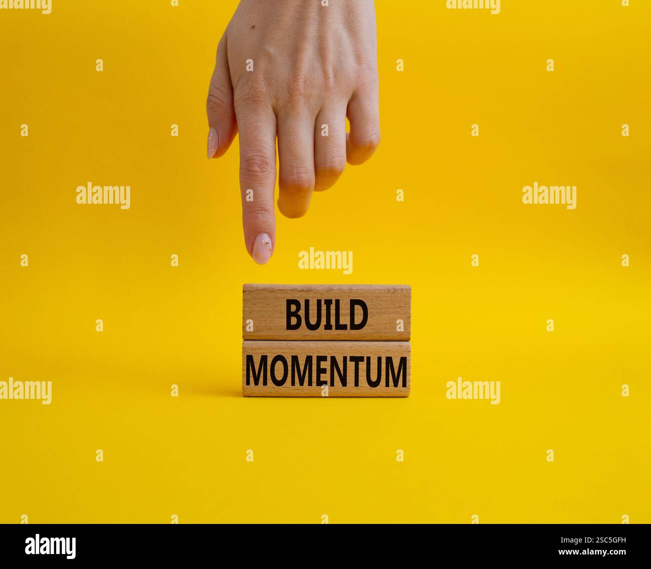 Build momentum symbol. Wooden blocks with words Build momentum ...