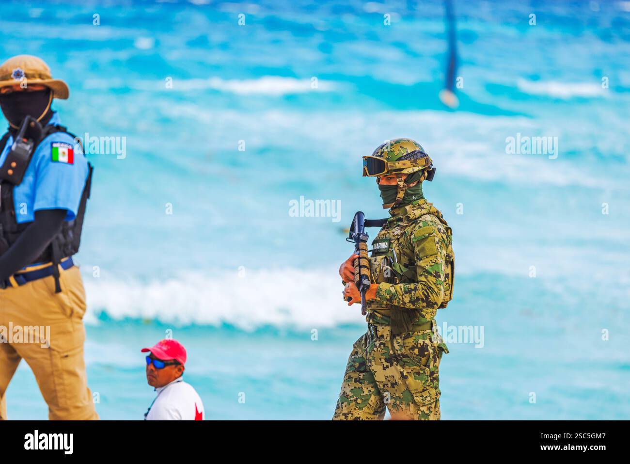 Armed soldier in camouflage uniform patrolling sandy beach near ...