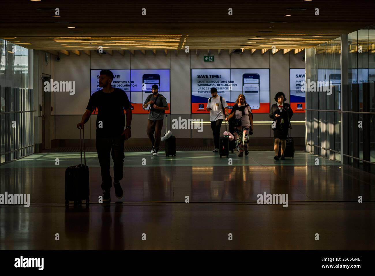 Toronto, Canada. 24th July, 2024. Travellers walk through Pearson ...