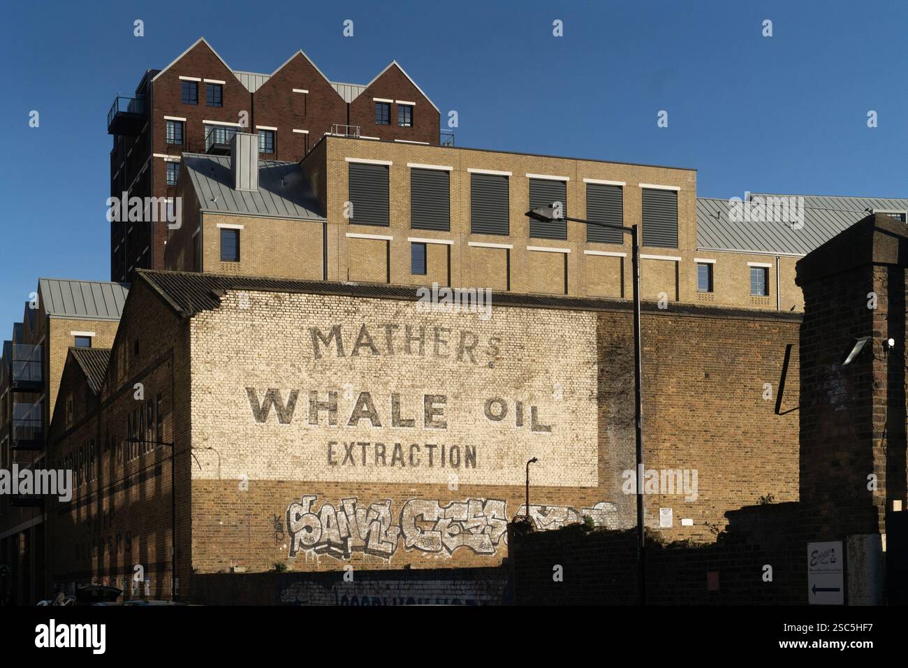 Vintage "Mather's Whale Oil Extraction" sign on a brick wall in London ...