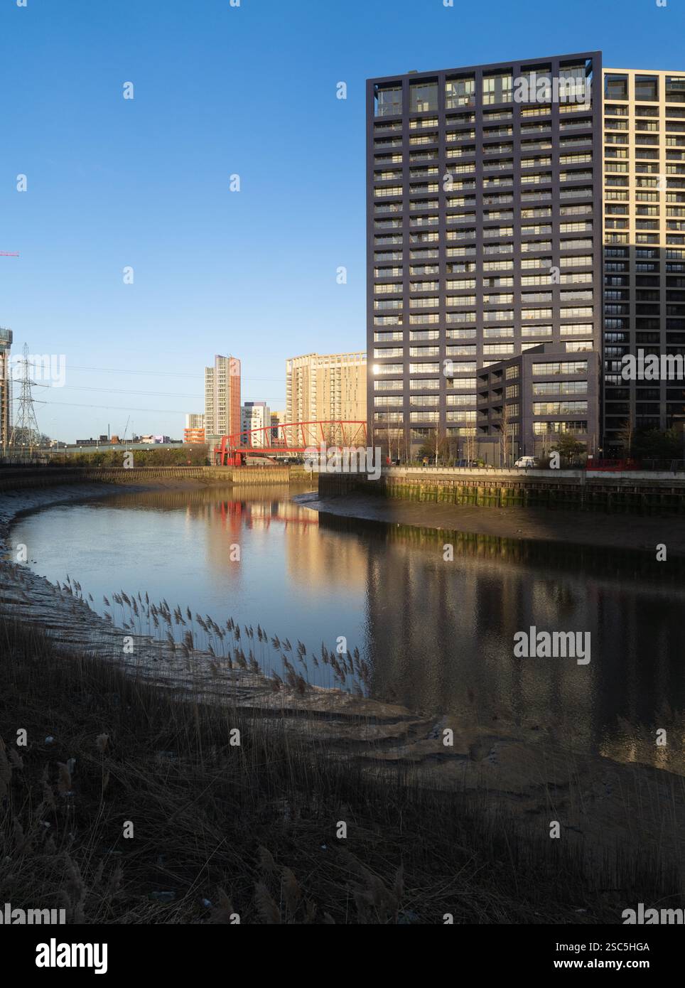 London, UK. River Lea, modern apartment buildings, and the red Jubilee ...