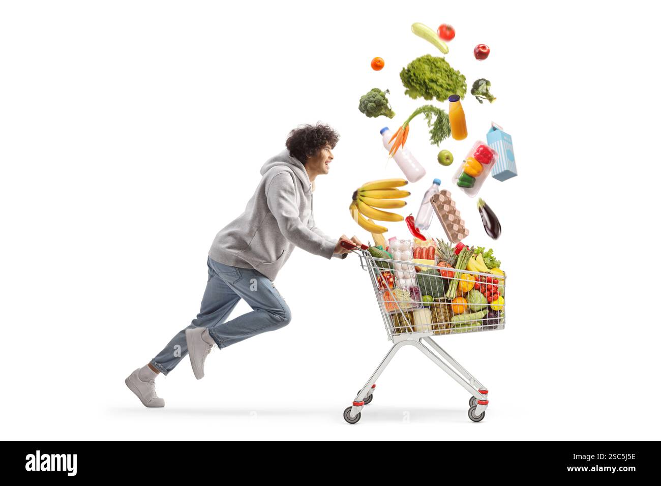 Young man running with falling food in a shopping cart, click and ...
