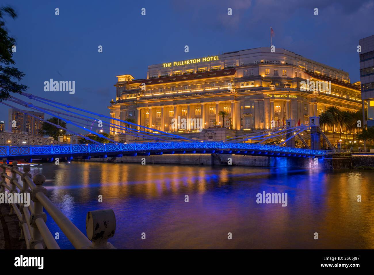 The deep blue span of the Cavanagh Bridge arcs over the Singapore River ...