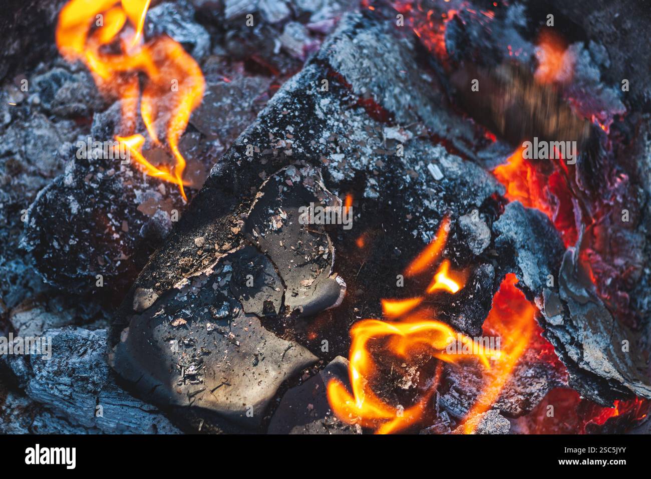 Glowing Amber Flames Over Dark Charcoal Ashes Stock Photo - Alamy