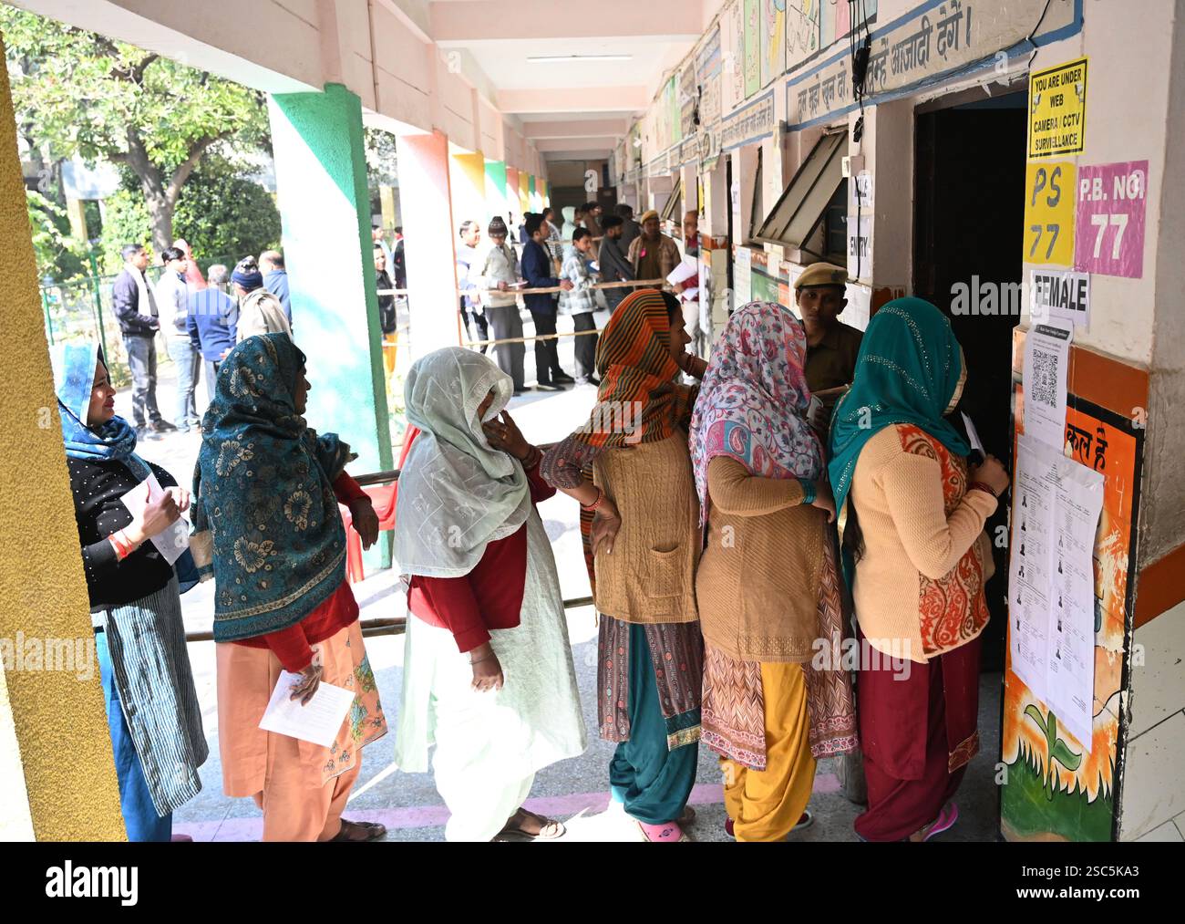 NEW DELHI, INDIA - FEBRUARY 5: People cast their vote at a booth centre ...