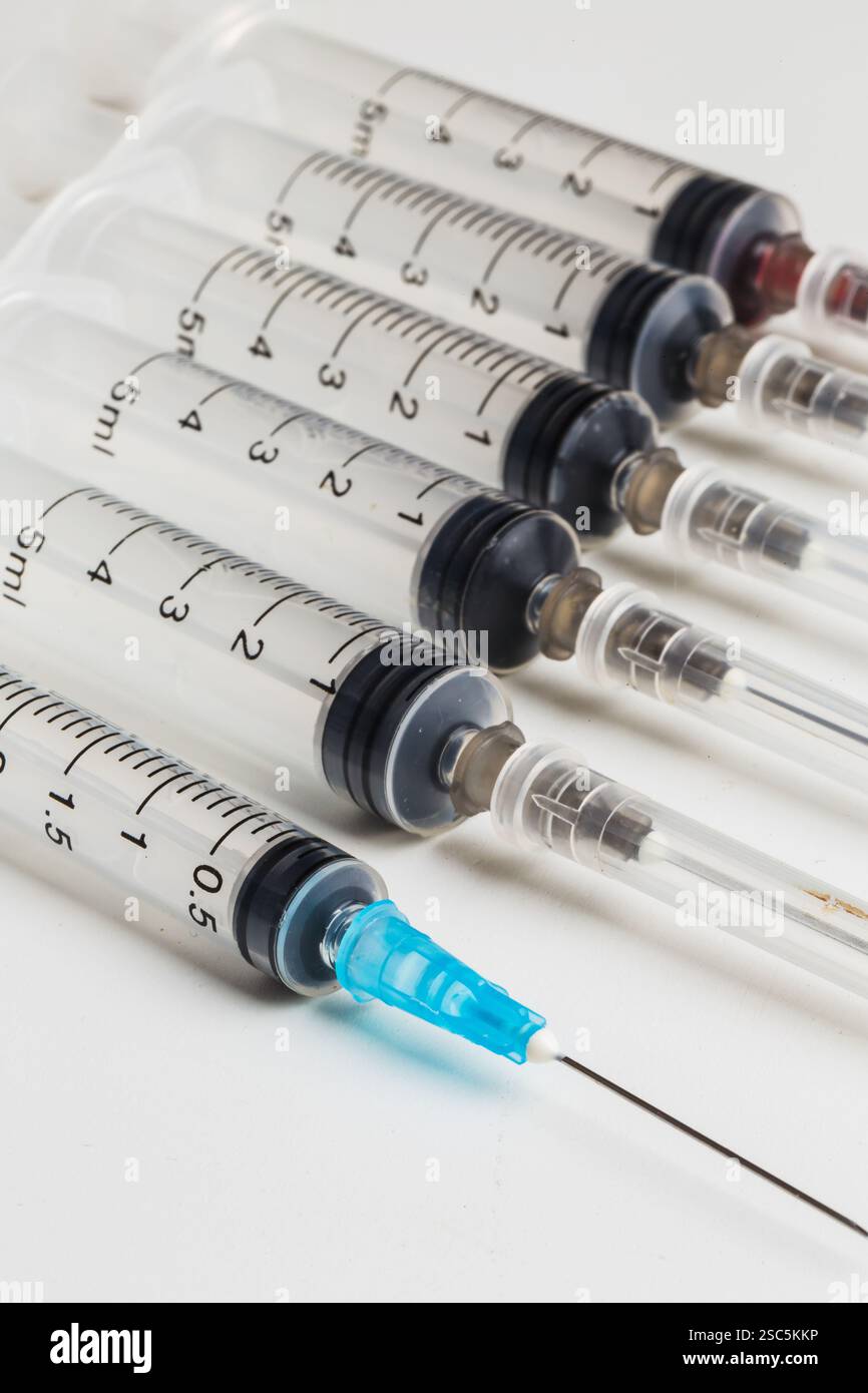 Closeup, Disposable syringe in the row on white background Stock Photo ...