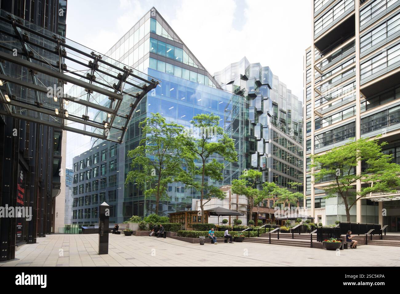 Fleet Place, London. People relax in a plaza between modern office ...