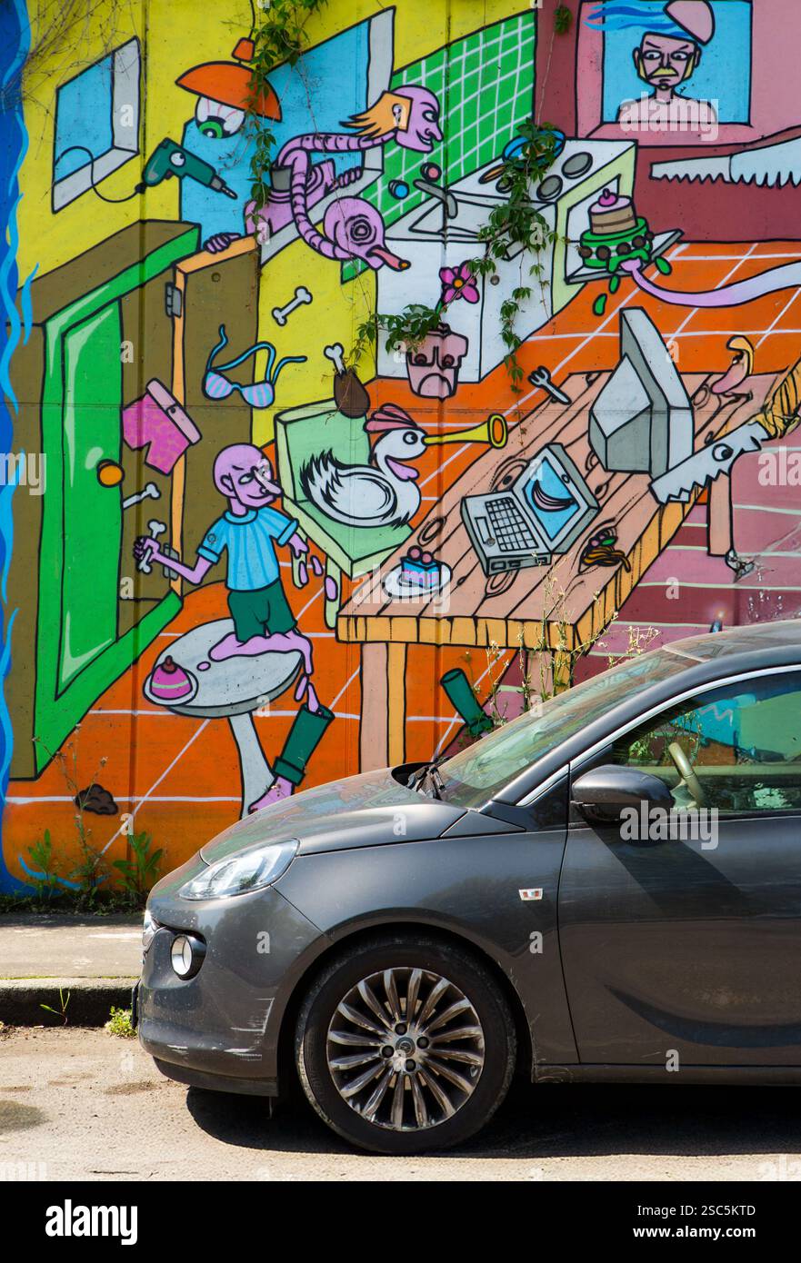 Parked cars along urban street, vibrant mural background with colorful ...