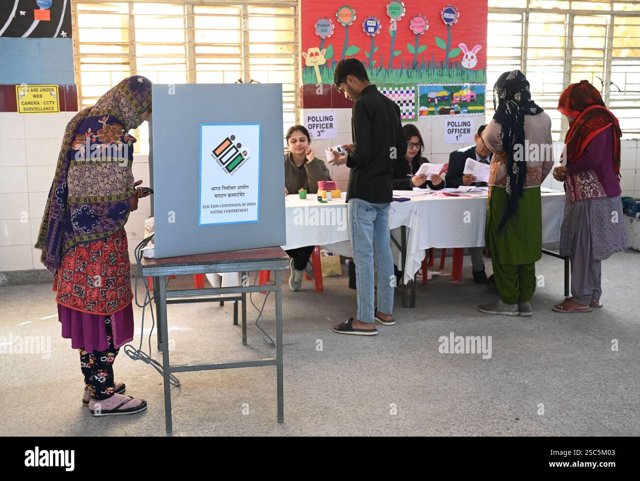 NEW DELHI, INDIA - FEBRUARY 5: People cast their vote at a booth centre ...