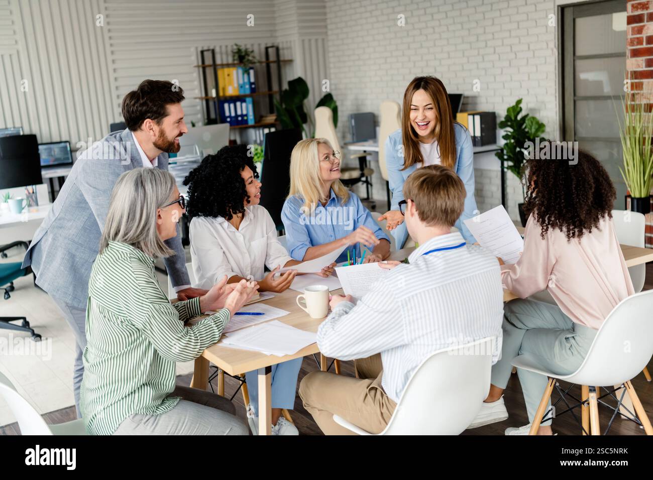 Collaborative coworkers brainstorming ideas at a group meeting in a ...