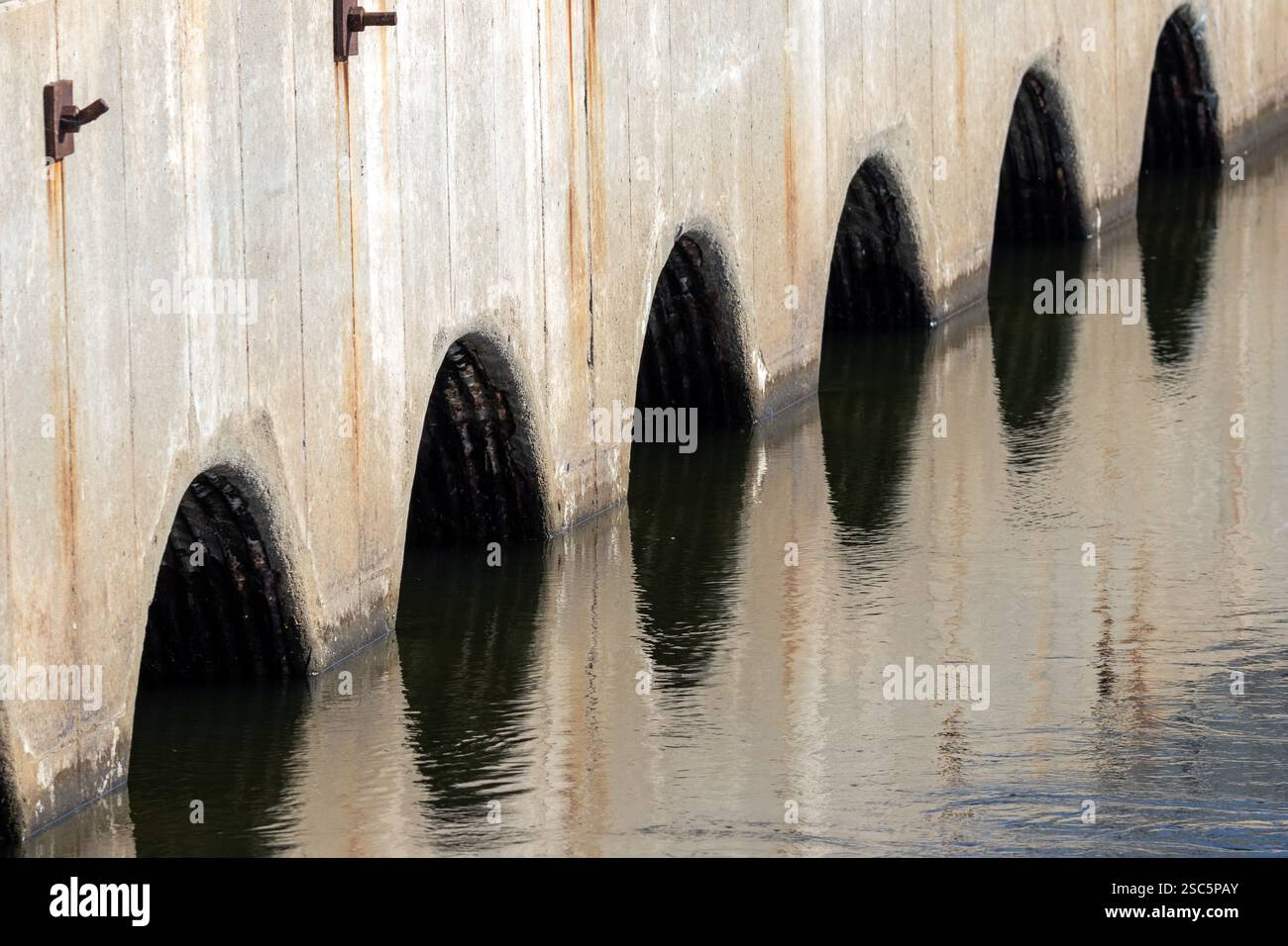 Concrete floodgate tunnel with water Stock Photo - Alamy