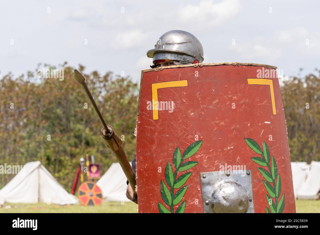 A detailed view of a Roman legionnaire's shield and golden helmet on ...