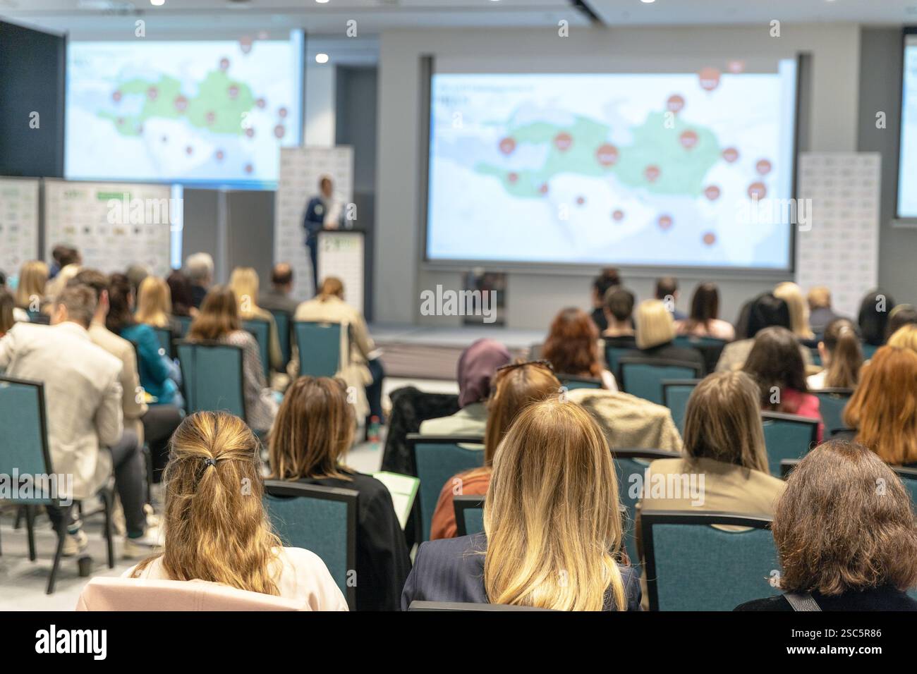 Audience attentively listening to a presentation in a modern conference ...