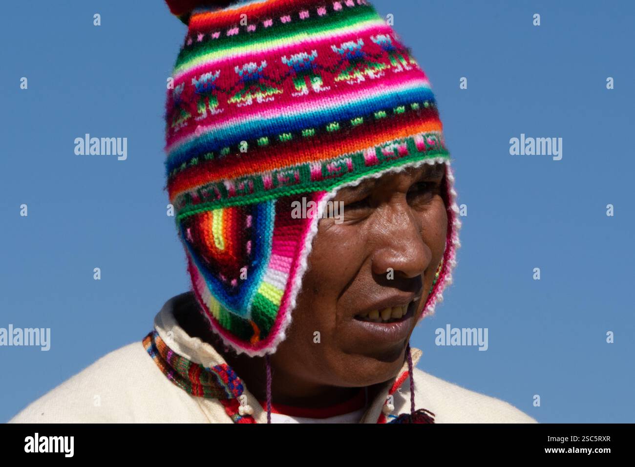 Portrait of a local Andean man in traditional colorful hat in Peru ...
