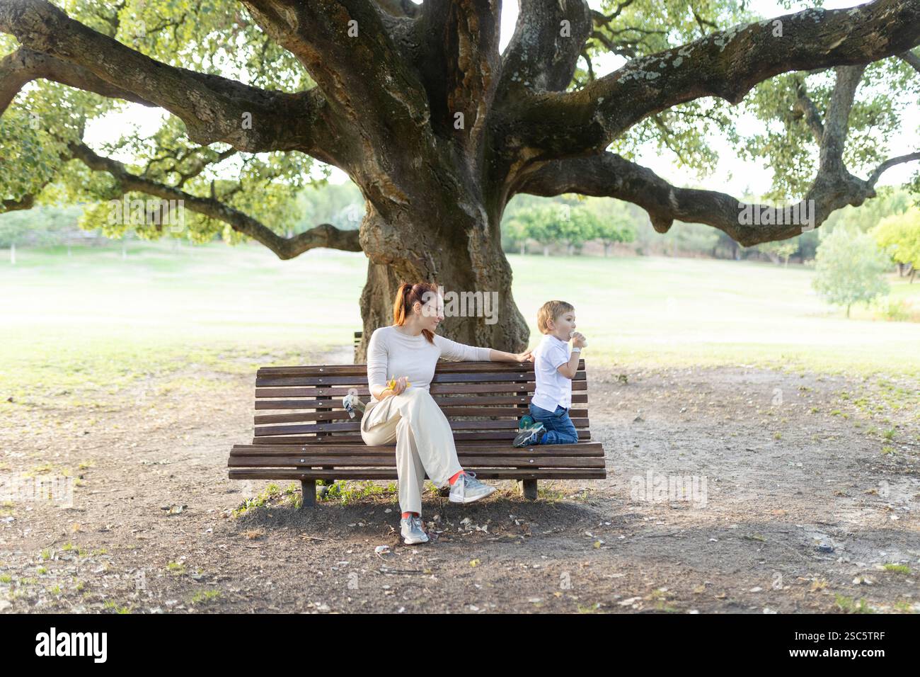 Mother and son sharing a pleasant moment on a park bench Stock Photo ...