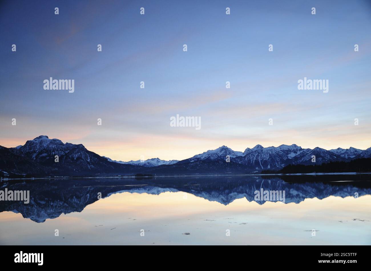 Sunset at the Forggensee near Fuessen in the Allgaeu, on the left the ...