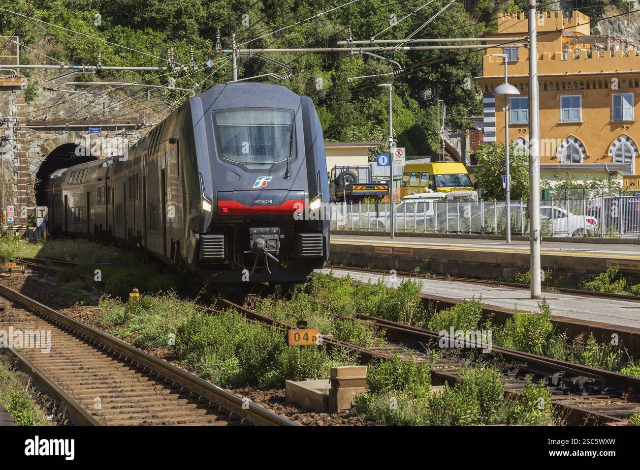 Hitachi commuter train arriving at Monterosso train station platform ...
