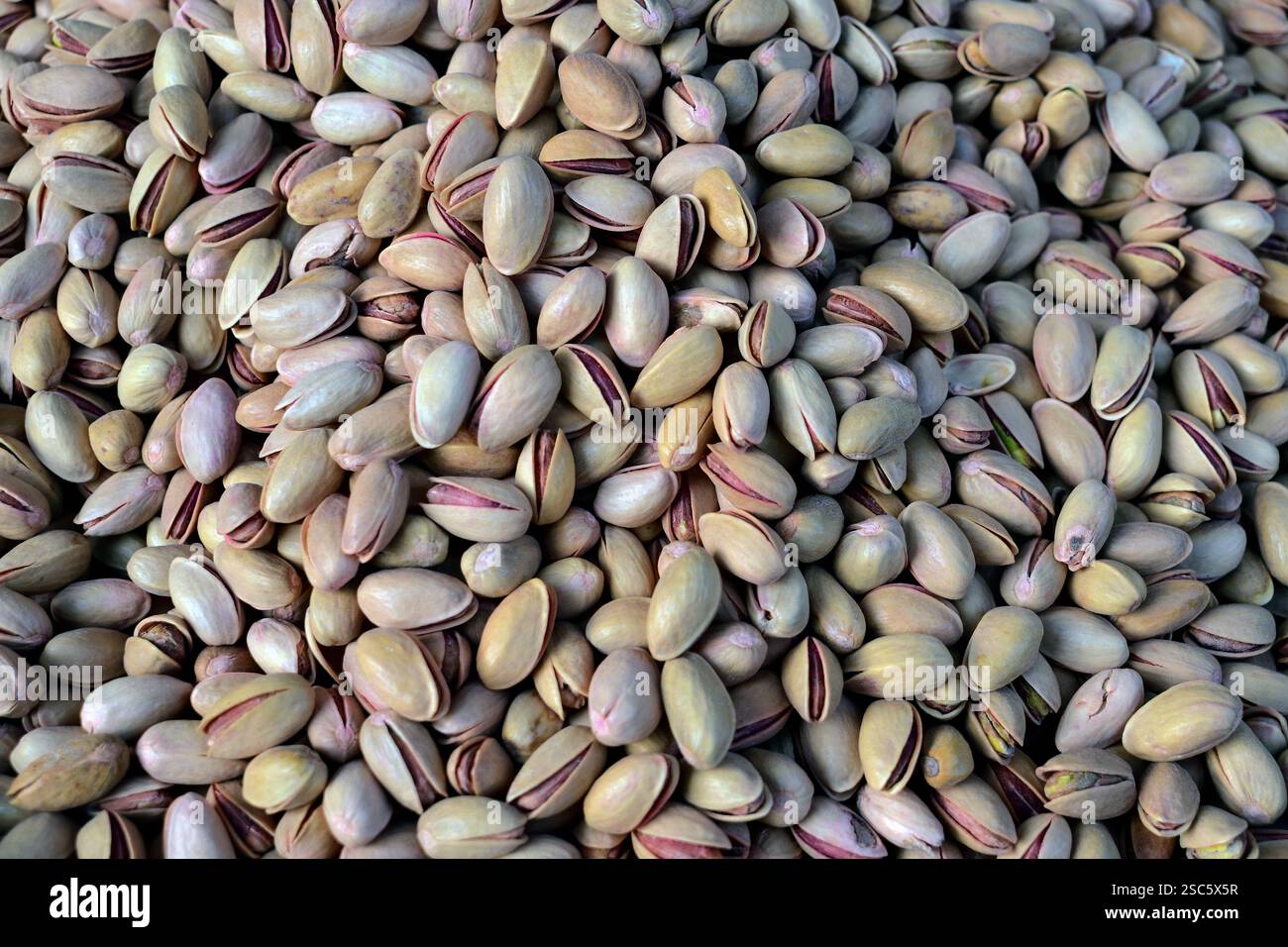 Roasted pistachio nuts in shells. Natural food peanuts stacked ...