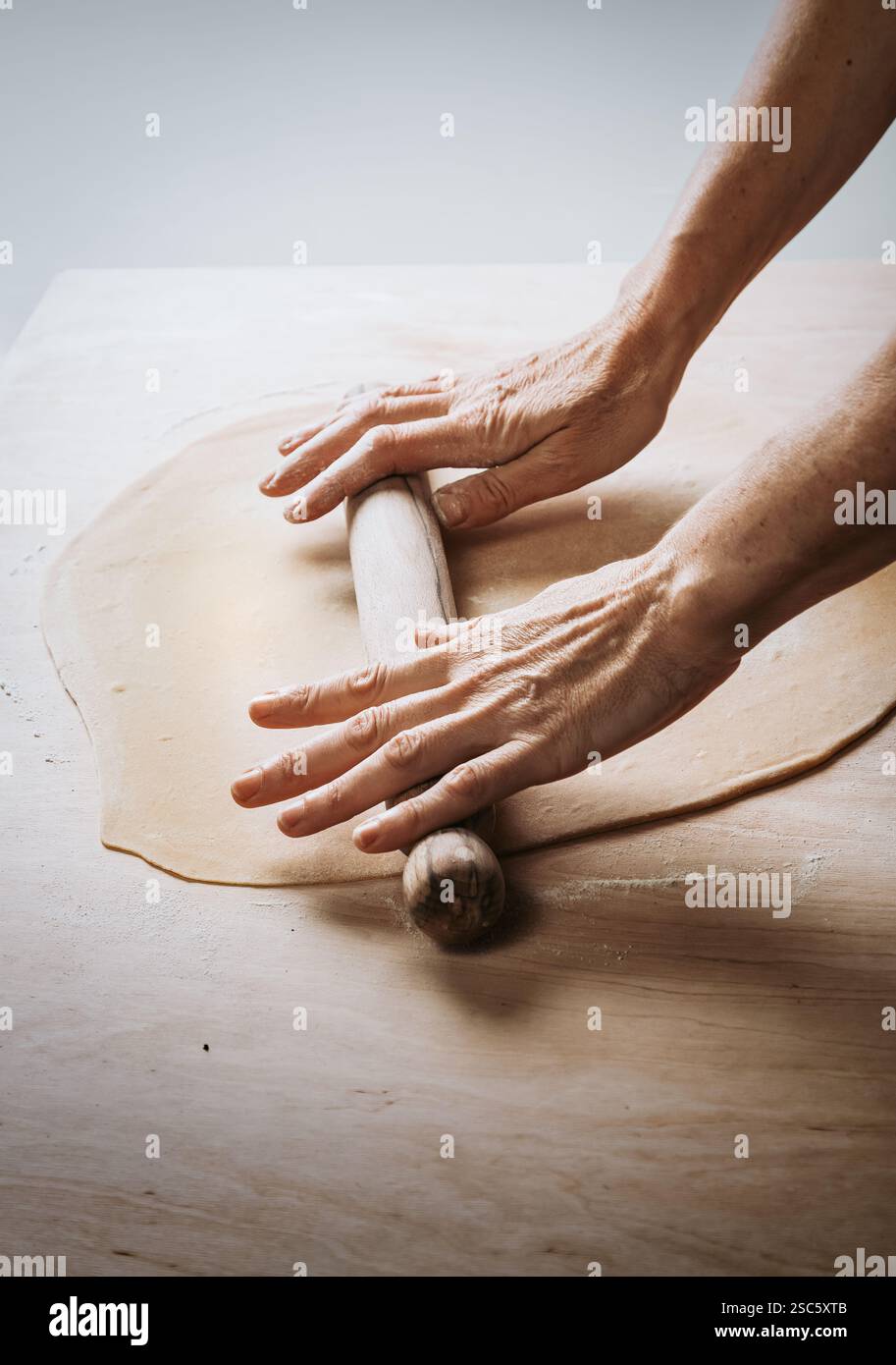 Homemade pasta preparation in Tuscany. The image shows the hands of a ...