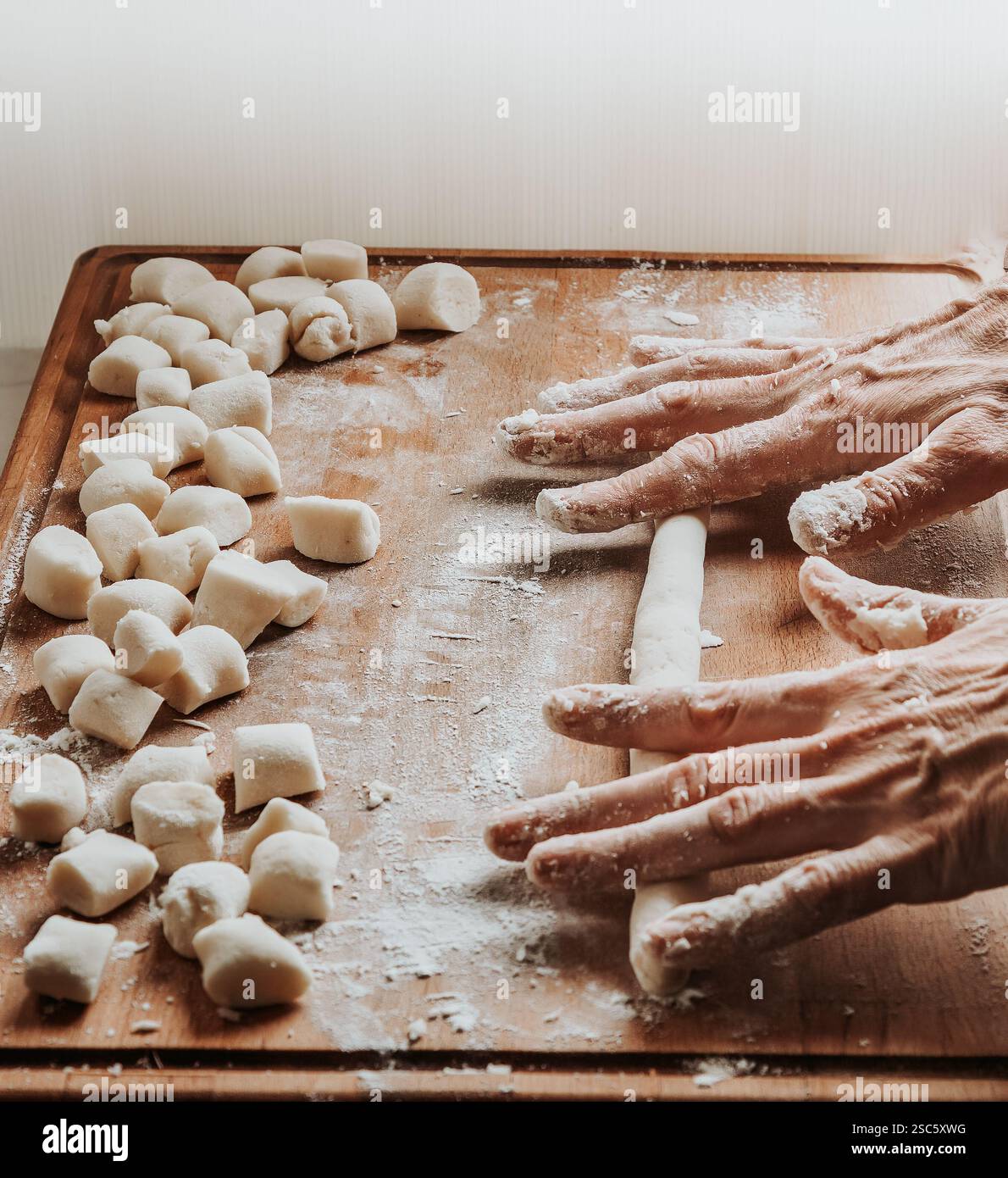 Homemade pasta preparation in Tuscany. The image shows the hands of a ...