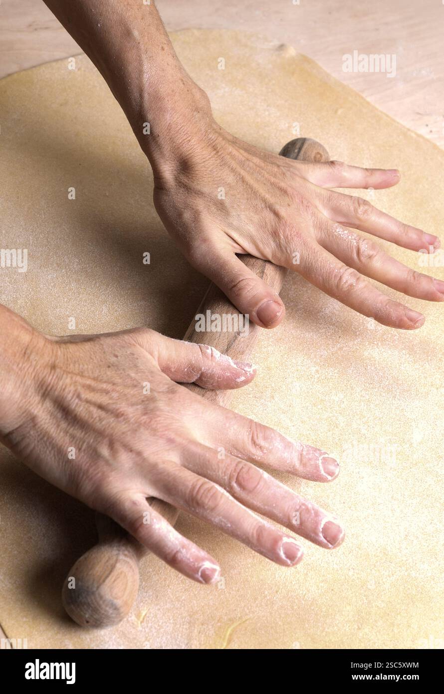 Homemade pasta preparation in Tuscany. The image shows the hands of a ...